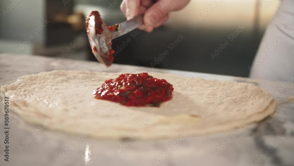 Italian chef making margaritta pizza with tomato sause and mozzarella ...