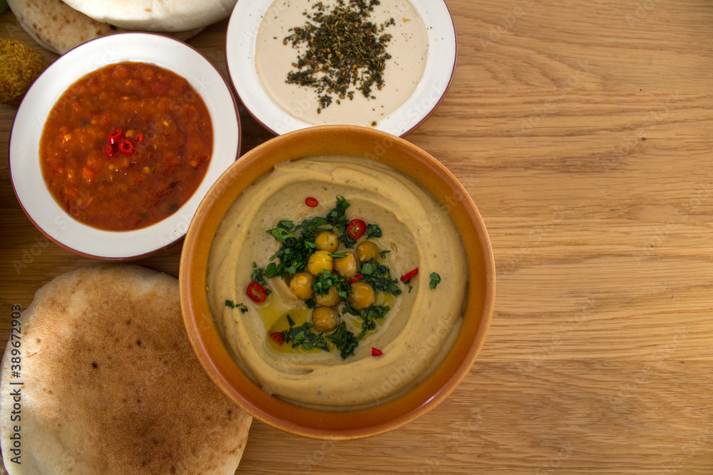 Israeli food close up photo. Falafels, hummea and pita bread on a table ...