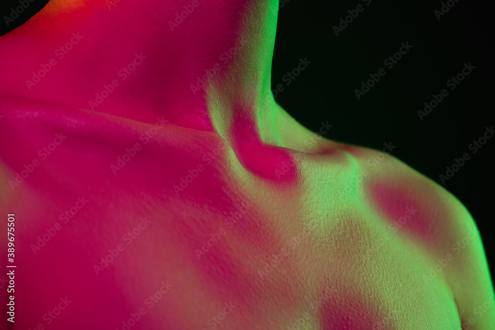 Collarbone. Portrait of female fashion model in green-pink neon light ...