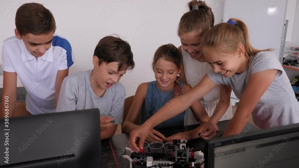 School children teenagers in robotics school makes robot managed from ...