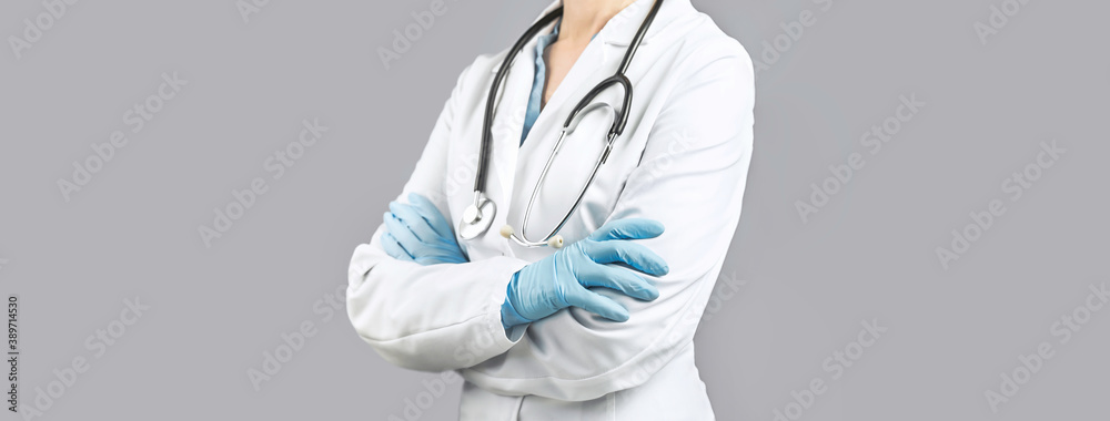 Female Doctor with crossed hands over grey background. Impersonal no ...