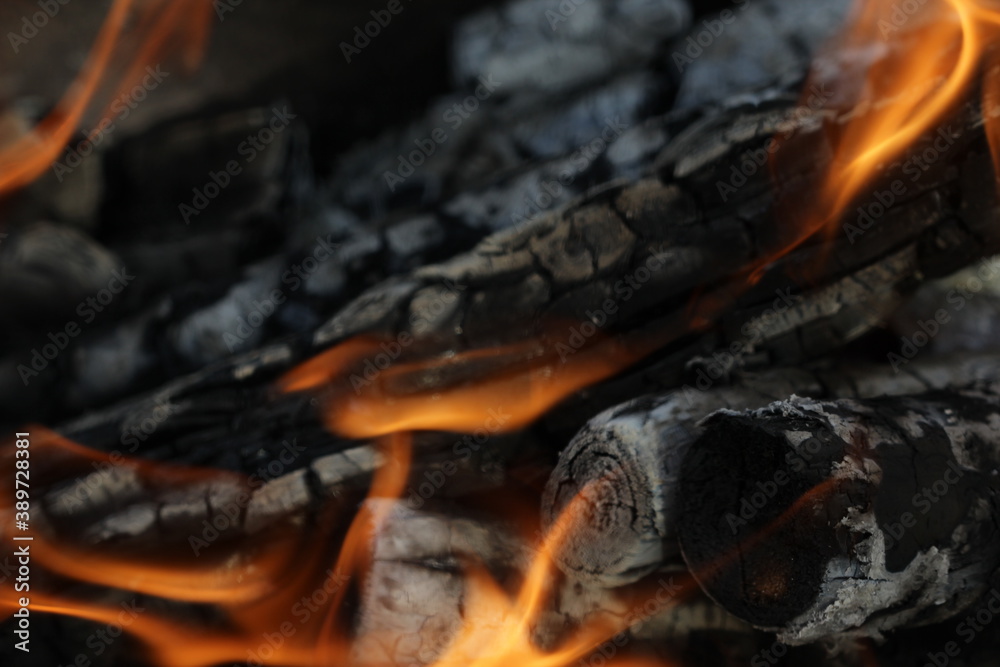 Smoldered logs burned in vivid fire close up. Atmospheric background ...