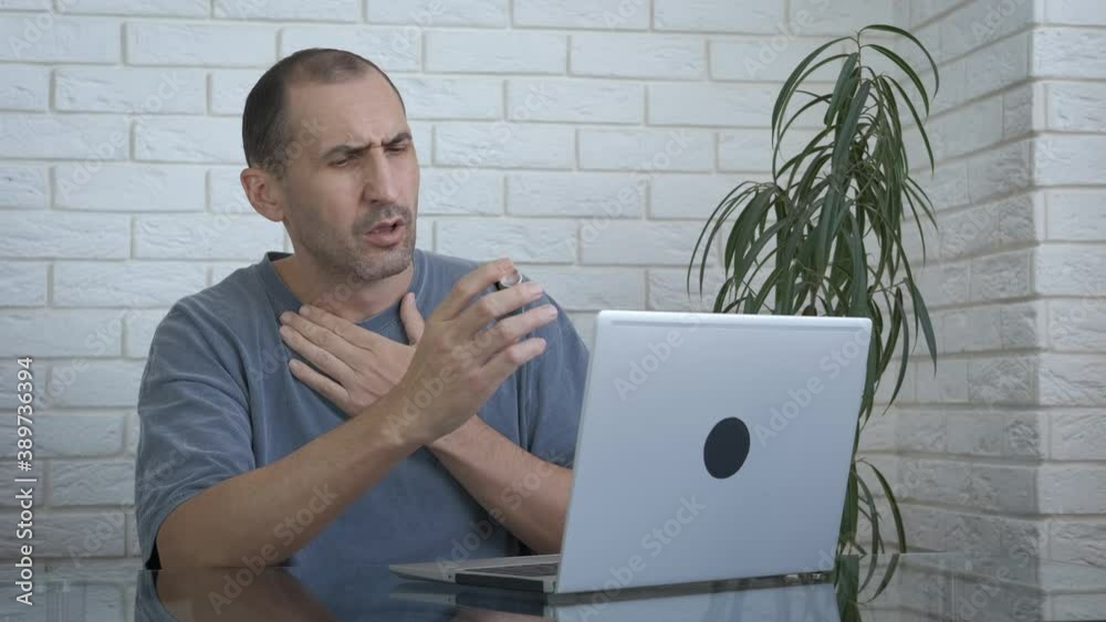 Asthma attack. The man is choking from asthma and uses an aerosol ...