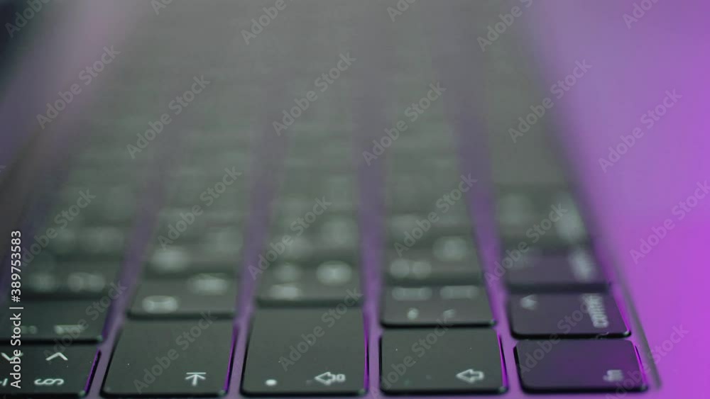 Side view of laptop or computer details, black keyboard with white ...