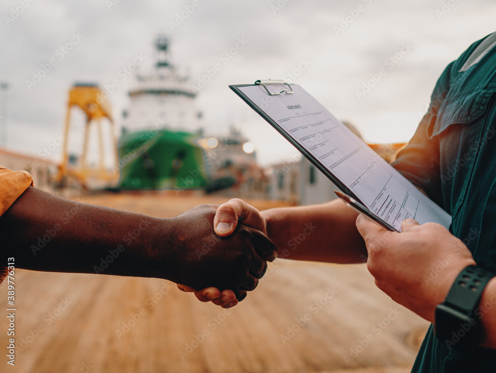 marine contractor businessman handshaking with worker on the ship with ...