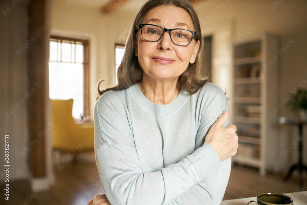 Beautiful casually dressed retired Caucasian woman posing indoors ...