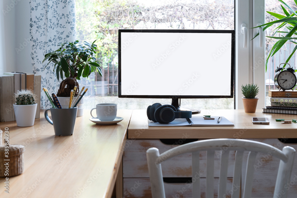 Workspace with blank monitor screen of computer on office desk near ...