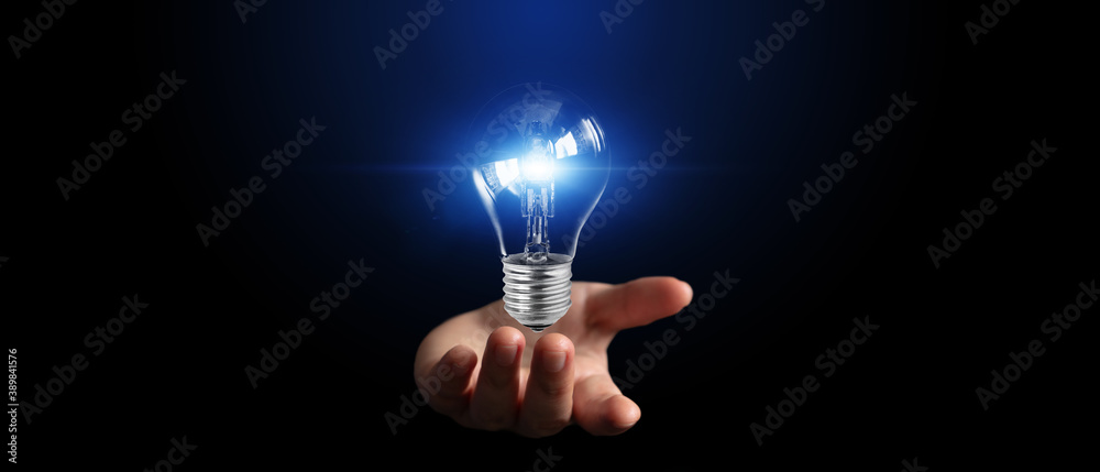 Abstract hand holding creative light lightbulb on isolated black ...