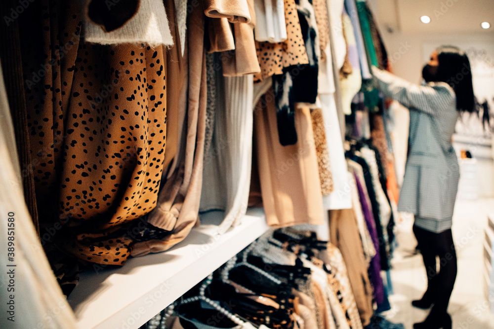 focus in foreground of a luxury fashion store with a selection of woman ...