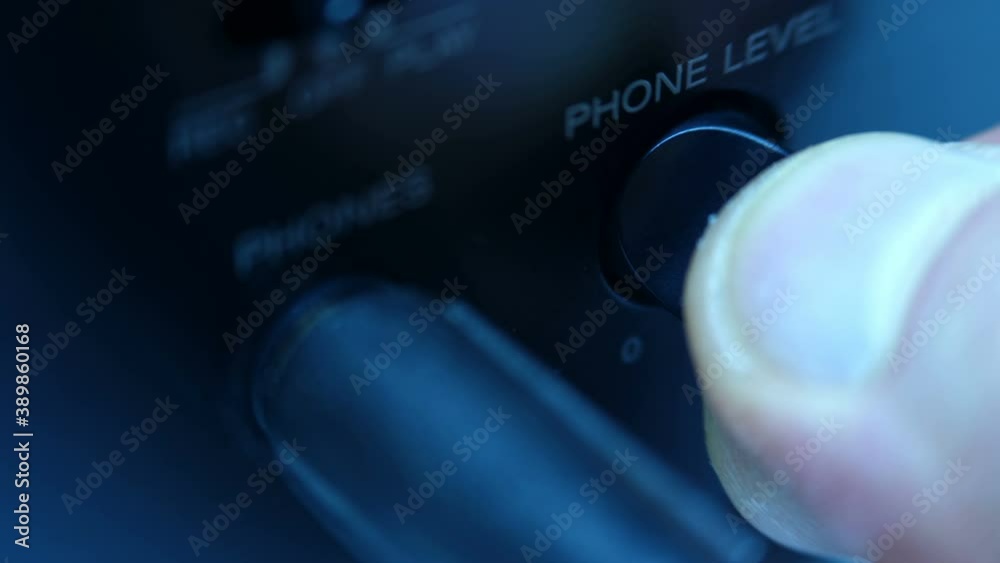 The hand inserts the plug into the headphone (microphone) jack on the ...