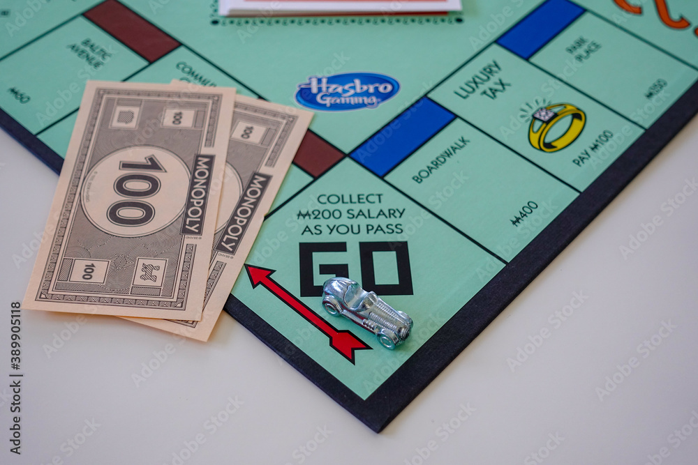 Car on the pass go space in the game Monopoly by Hasbro on a white ...