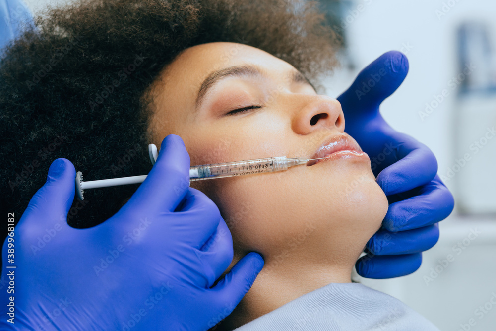 Attractive young African woman is getting a rejuvenating facial ...
