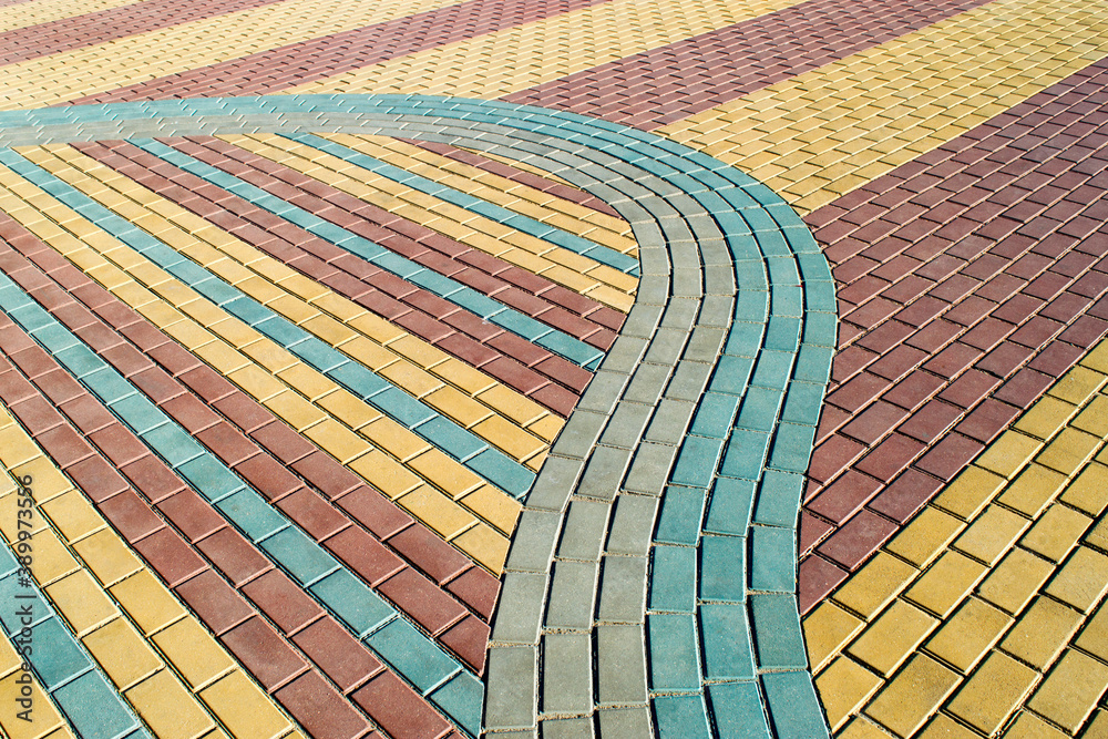 The area is paved with paving slabs with diagonal and curved patterns ...