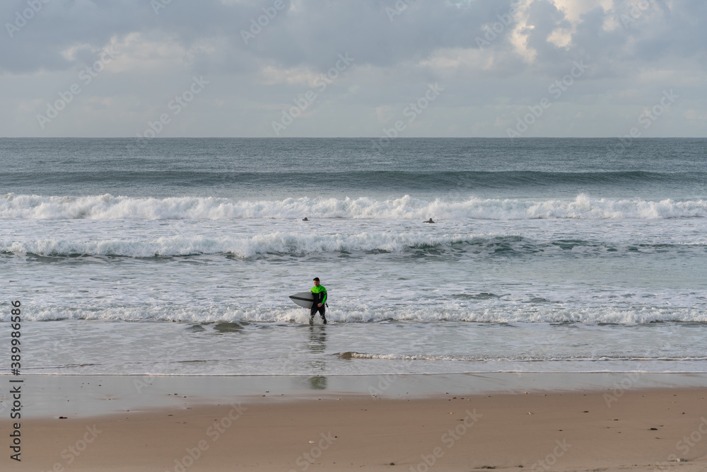 Surfers surfing in Baleal Island beach atlantic ocean waves in Peniche ...