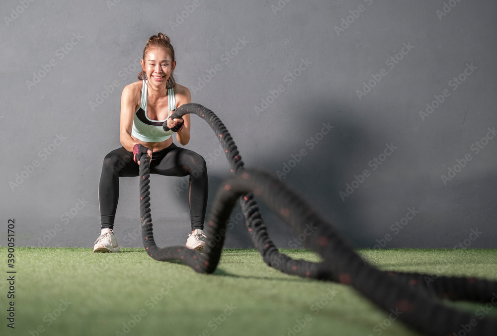 Strong muscle woman workout with rope in training fitness gym Stock ...
