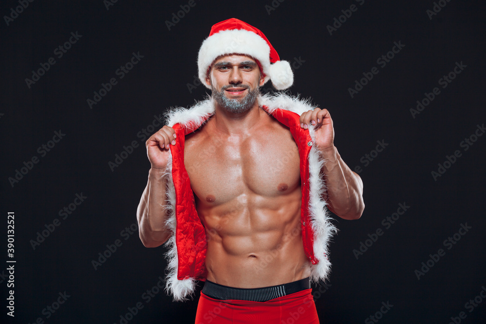 Sexy Santa Claus. Bodybuilder young handsome santa clause smile wearing ...