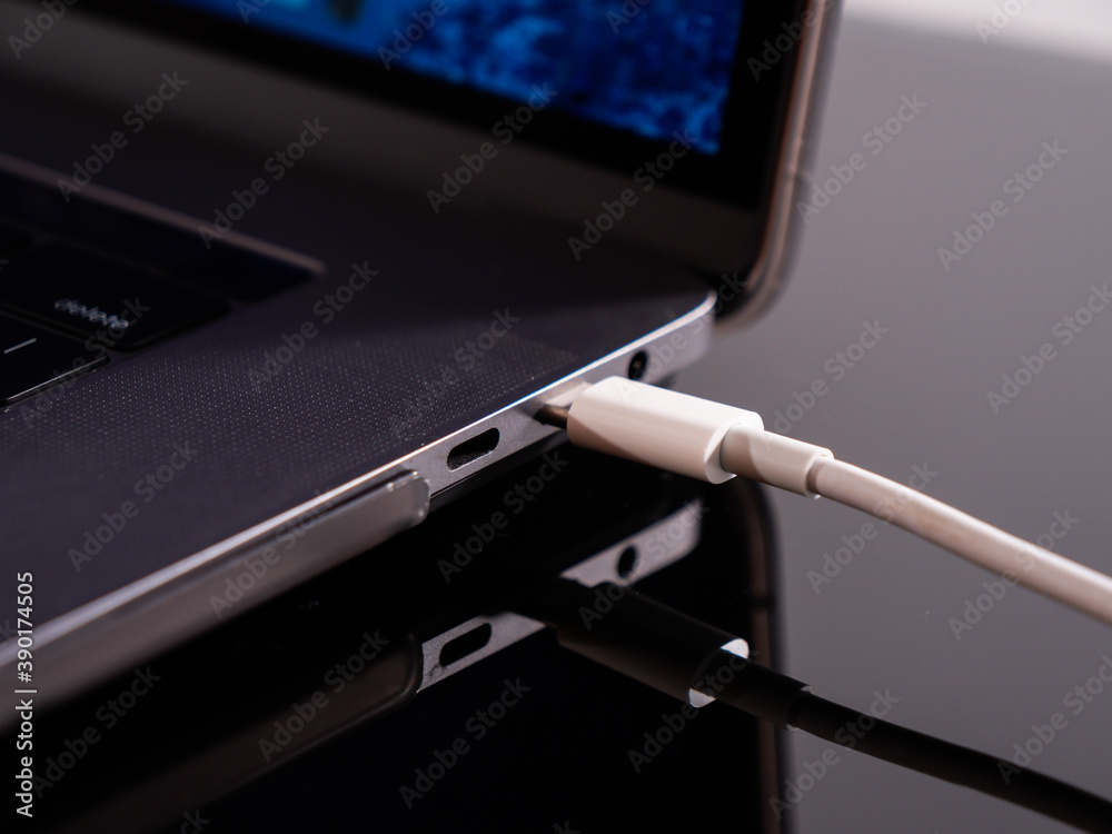USB Type C cable being connected to the laptop computer. Fast charging ...