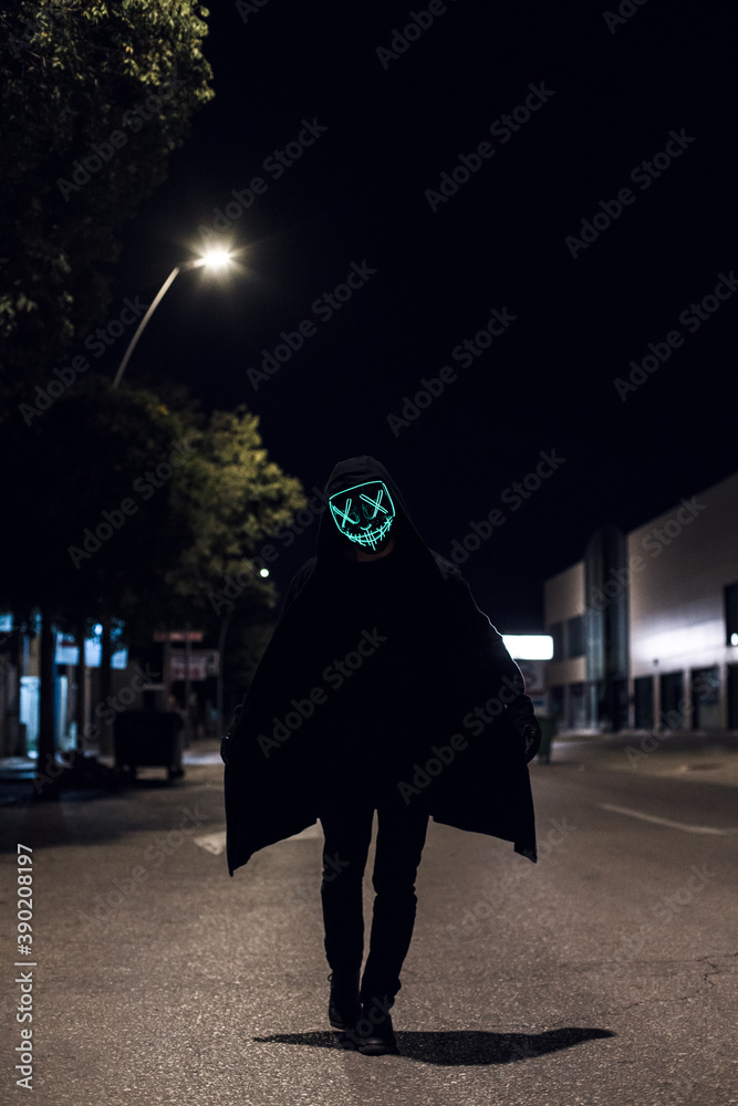 Scary masked man at night Stock Photo | Adobe Stock