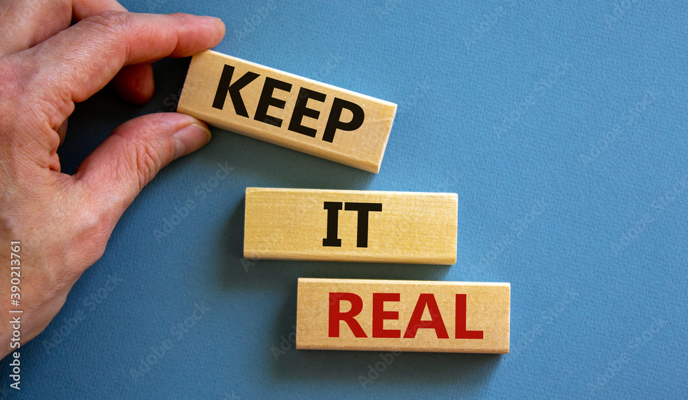 Wooden blocks with words 'keep it real'. Beautiful blue background ...
