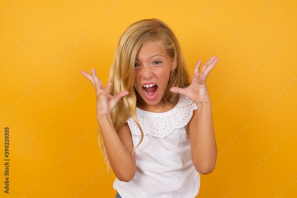 Beautiful Caucasian young girl standing against yellow background ...