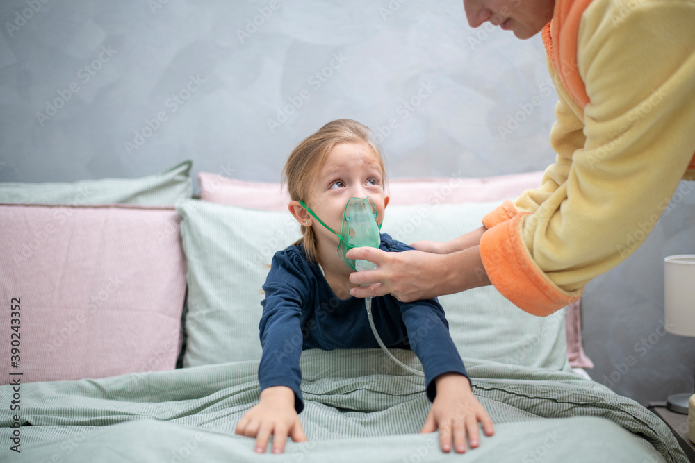 inhalation, aerosol, a 6-year-old girl does inhalation in the bedroom ...