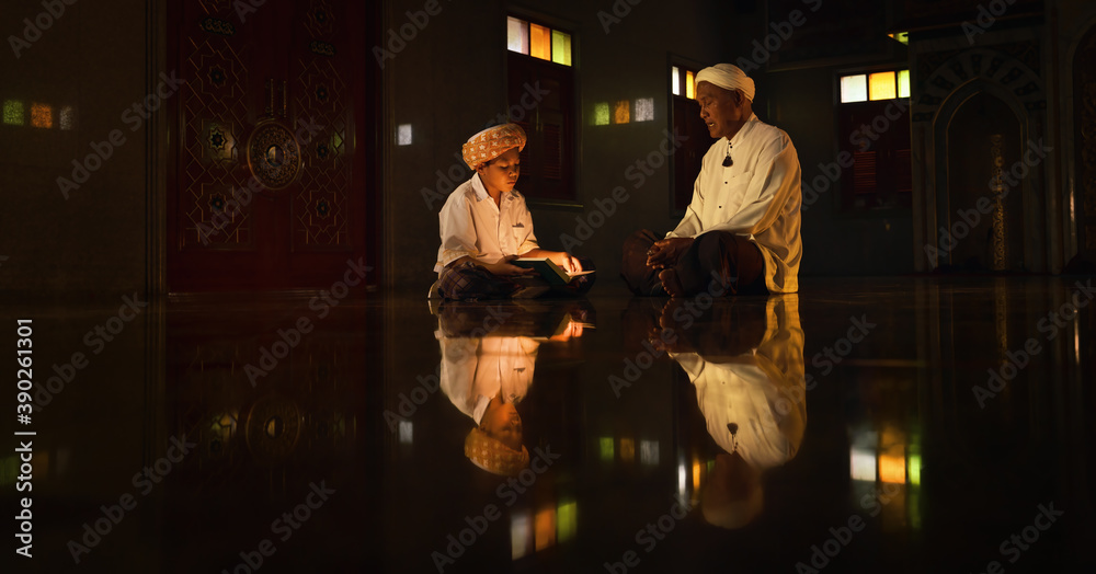 muslim boy sitting in mosque with islamic teacher learning koran book ...