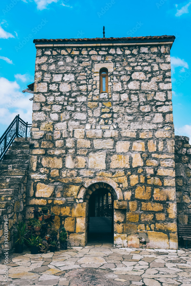Medieval stone castle tower. Old brown stone wall with window and door ...