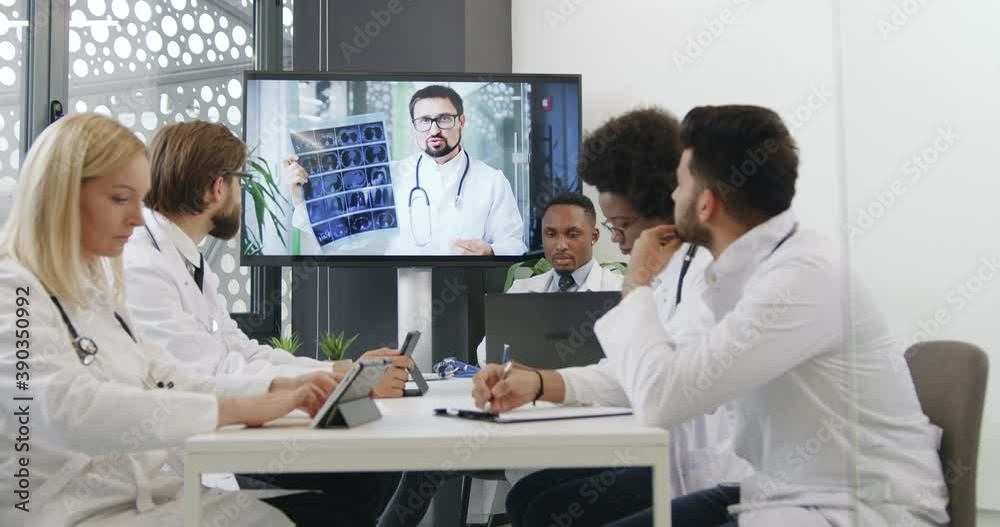 Front view of high-skilled good-looking concentrated mixed race medical ...