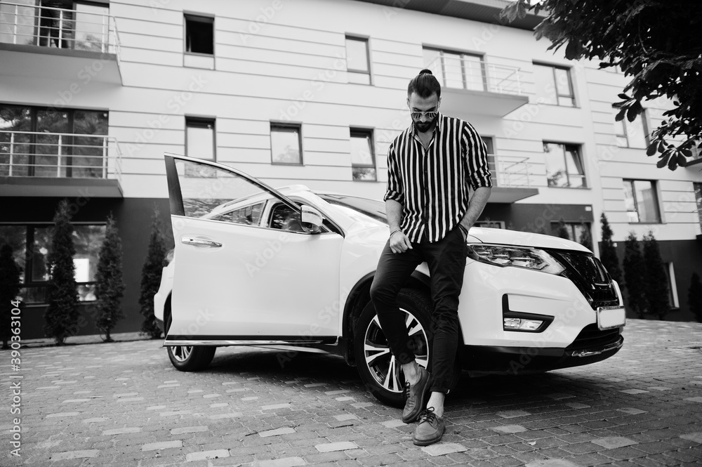Successful arab man wear in striped shirt and sunglasses pose near his ...