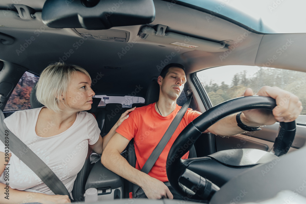 Wife wakes up tired husband, falling asleep at wheel of car. Dangerous ...