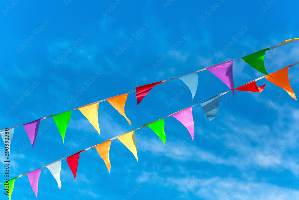 Colorful bunting flags in the wind. Festive background for holidays ...