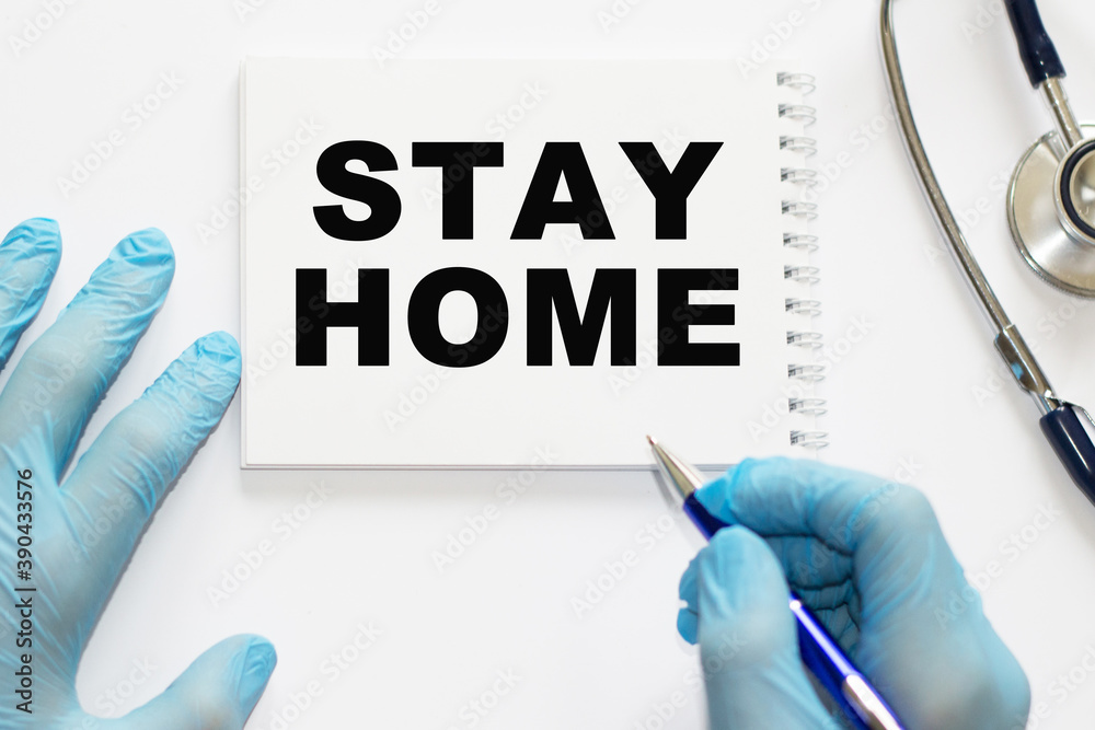 stay Home. stethoscope on the table with a letterhead and a pen. CARD ...