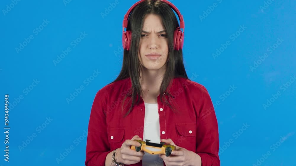 Sad girl loses in the video game in the studio.Excited gamer woman ...