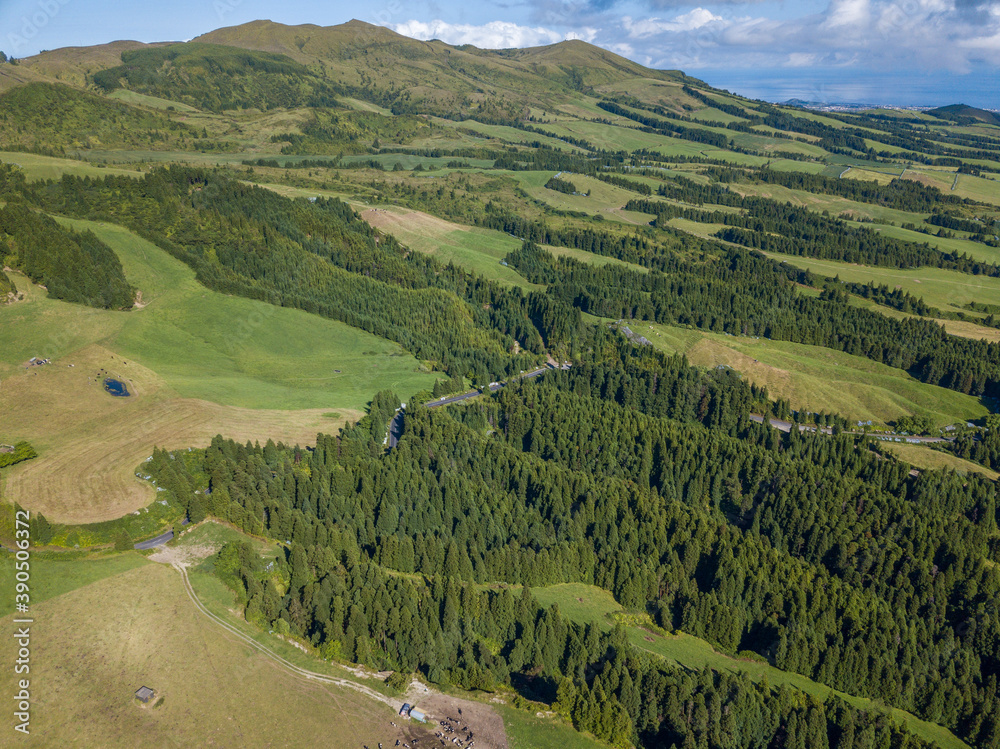 Overhead aerial top view over forest in Sete Cidades. Mountain curve ...