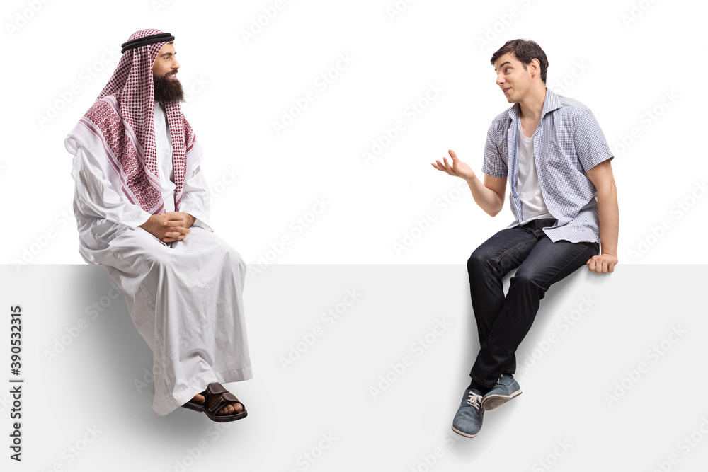 Young man and an arab sitting on a panel and talking Stock Photo ...