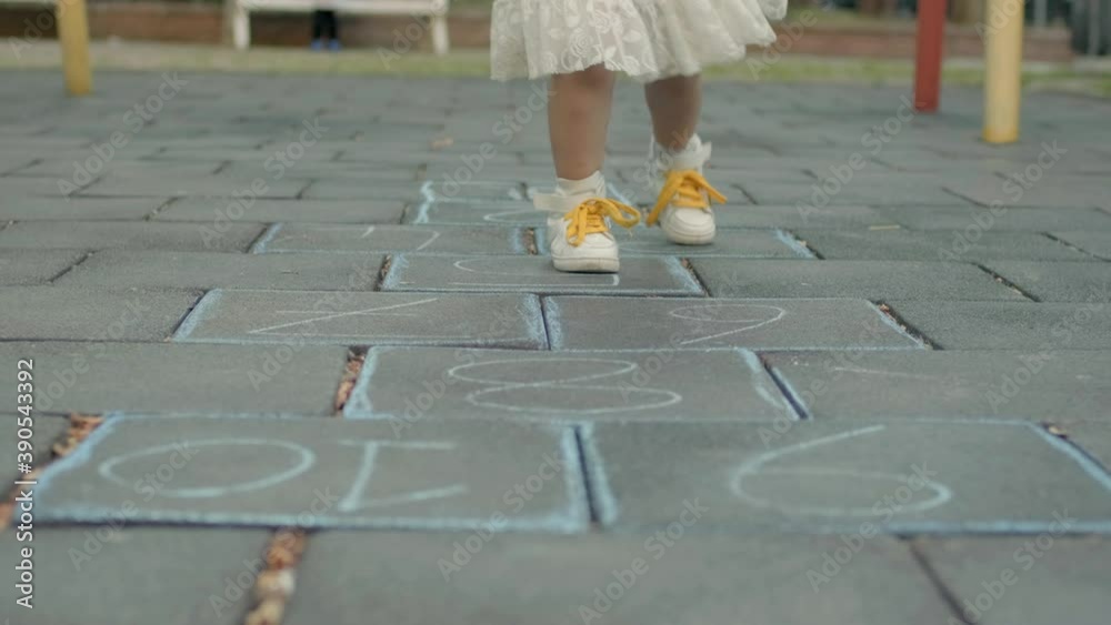 Little girl playing hopscotch in the park. Close up feet. Stock Video ...