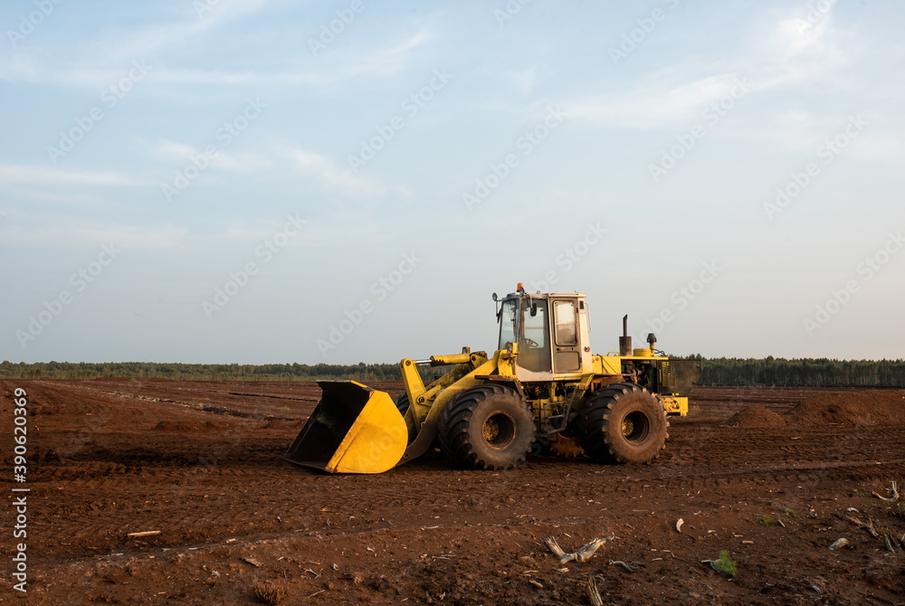 Wheel loader on peatlands at extraction site. Peat Moss Harvesting ...