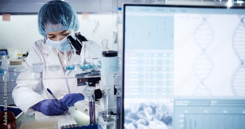 Asian female doctor working on biohazardous samples in laboratory ...