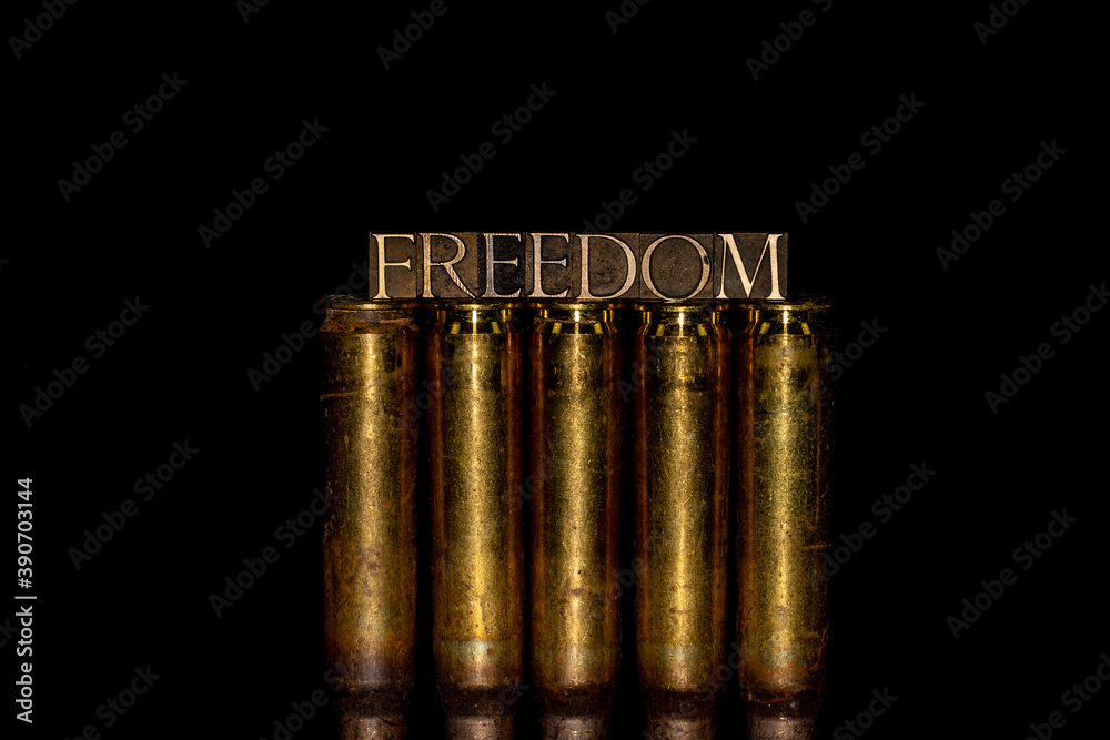 Freedom text message on 50 cal bullet casings against black background ...