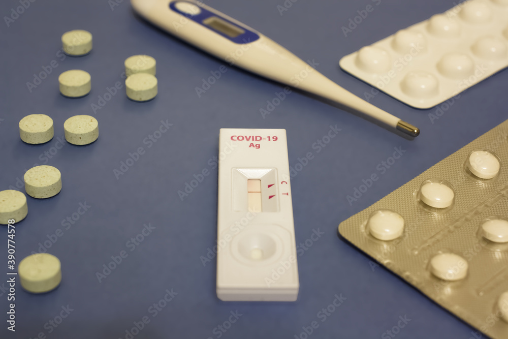 Rapid COVID-19 test, thermometer and pills for treatment. Worldwide ...