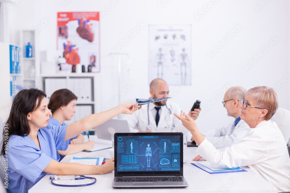 Group of medical staff discussing in hospital meeting room about ...