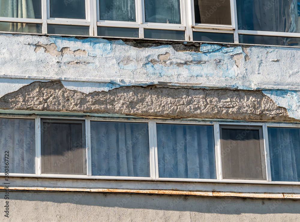 Old worn out communist apartment building with cracked peeling paint ...