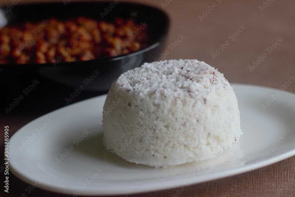 Steamed rice cake with layers of freshly grated coconut in between, a ...