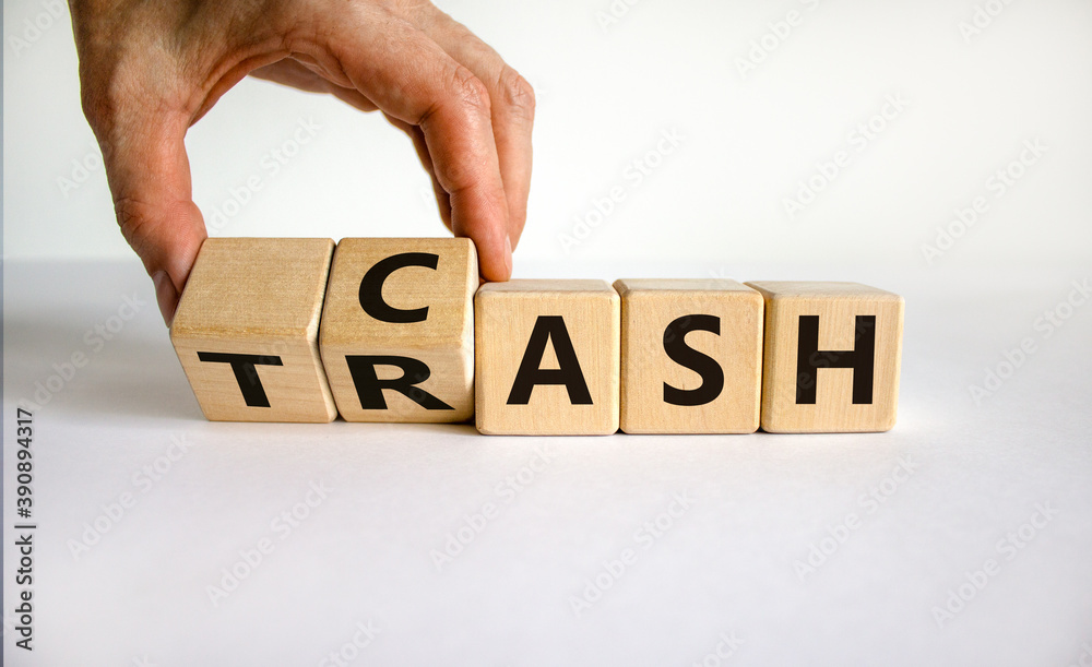 From trash to cash. Male hand flips wooden cubes and changes the word ...