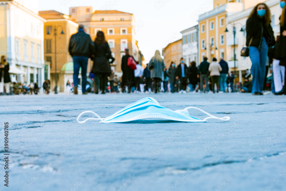 blurry concept.crowd of people walking in a city square wearing ...