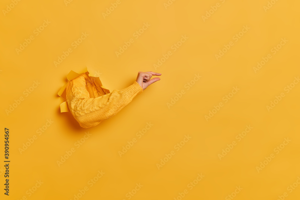 Womans hand in long sleeved jumper showing small size with two fingers ...