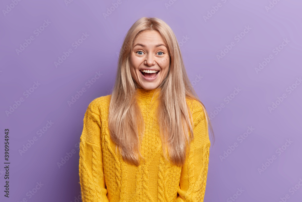 Overjoyed glad blonde European woman with pale face keeps mouth wide ...