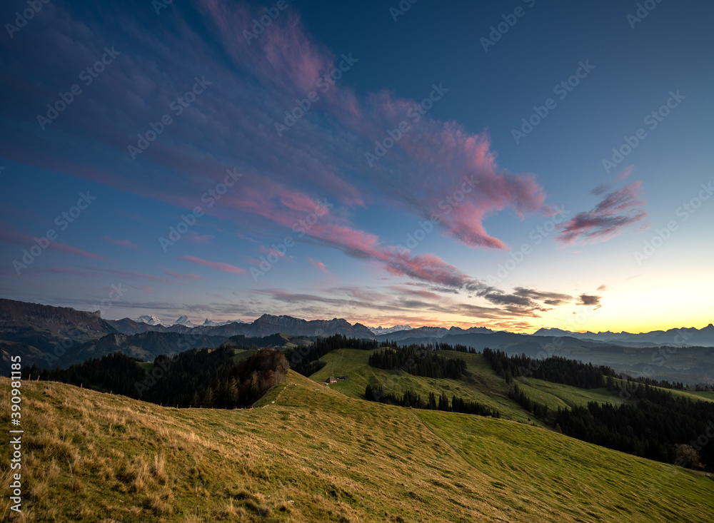 overview swiss landscape with hills forests mountains in warm color ...