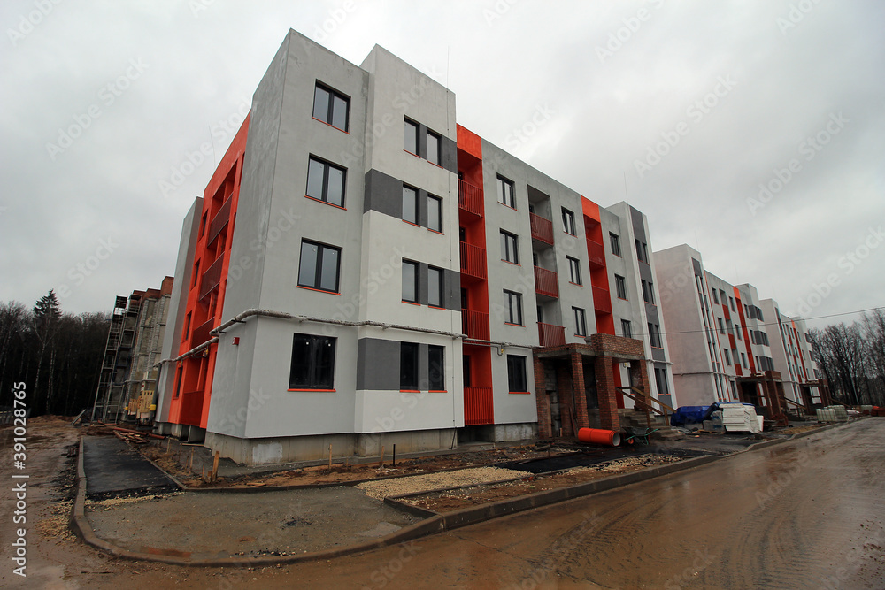 Tall building under construction with scaffolds. Construction site ...
