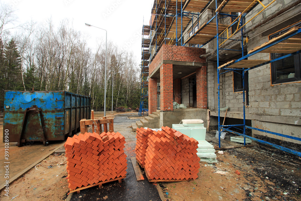 Tall building under construction with scaffolds. Construction site ...